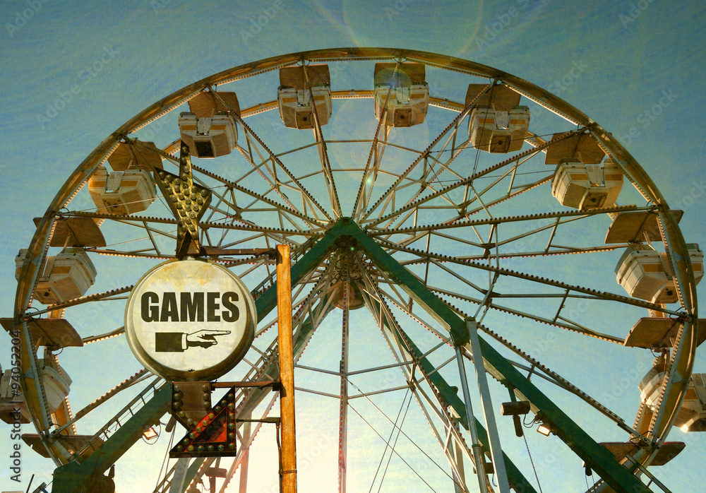 aged and worn vintage photo of carnival games sign with ferris wheel ...