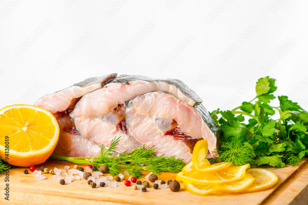 raw sliced steak of sturgeon fish with greens, lemon, different Stock ...