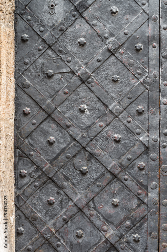 Ancient iron door with handle reinforced with steel belts and rivets ...