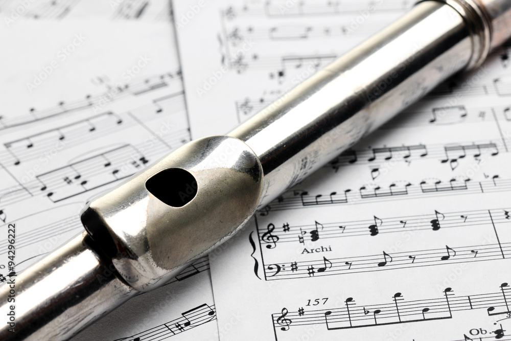 Old rusty silver flute on music notes Stock Photo | Adobe Stock