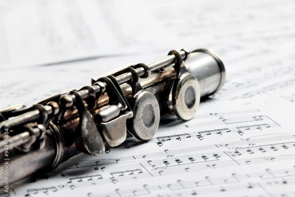 Old rusty silver flute on music notes Stock Photo | Adobe Stock