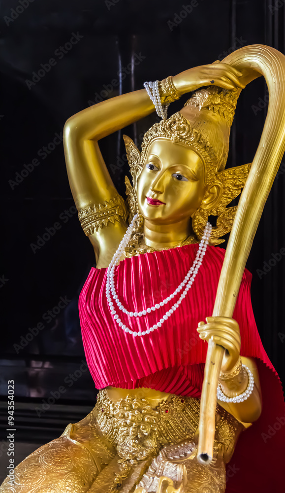 Statue of Phra mae thorani twisting her hair , the buddhist goddess of ...