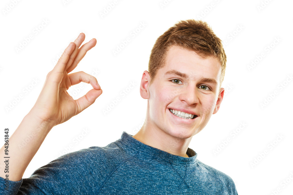 Young man showing ok hand sign gesture Stock Photo | Adobe Stock