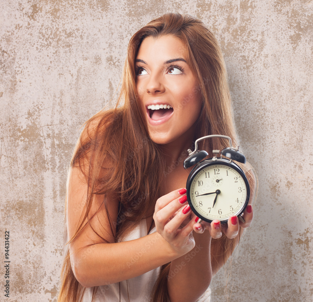 Portrait of a pretty young woman holding an alarm clock Stock Photo ...
