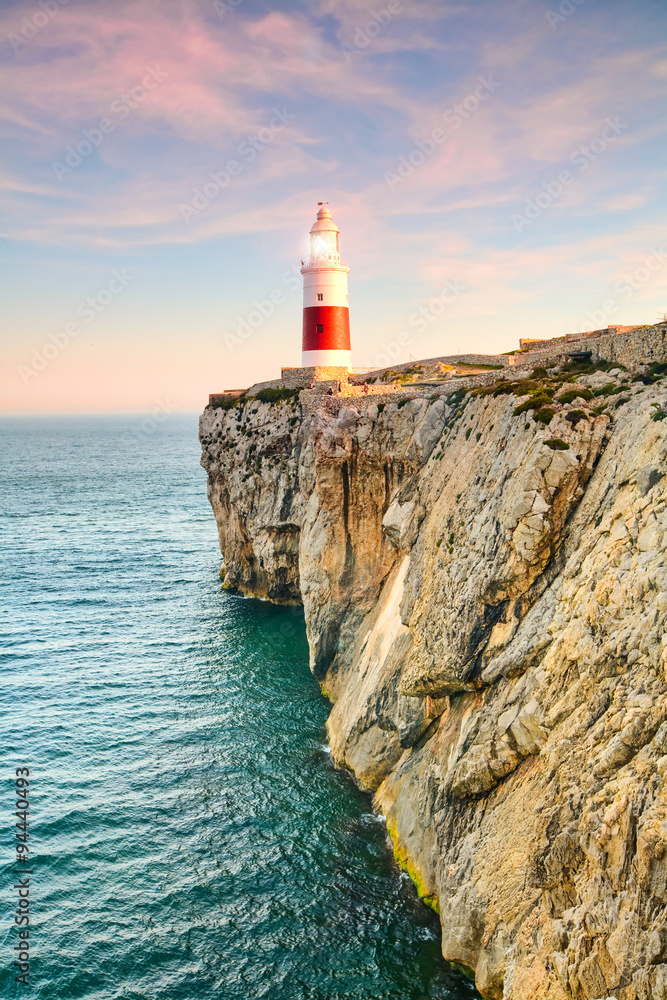 Poster A picturesque sunset over Gibraltar's famous Trinity lighthouse ...