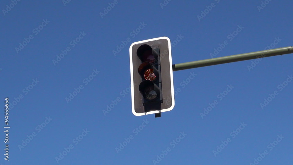 orange blinking traffic light in Madrid city Spain Europe on blue sky ...