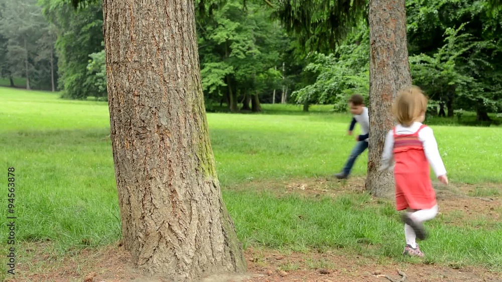 children (siblings - little boy and cute girl) playing in the park ...
