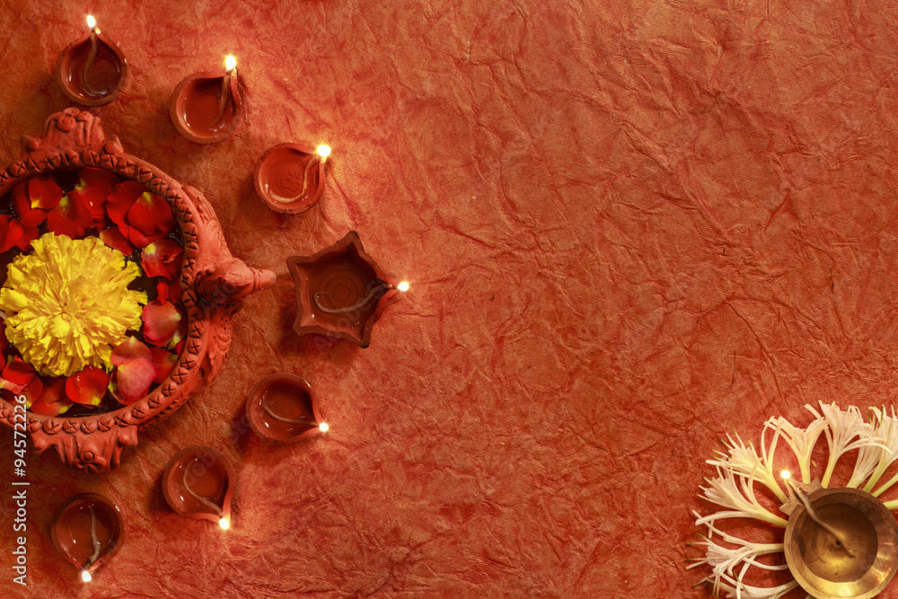 Diwali festival, Lighting of diya and decoration of flower surrounding ...