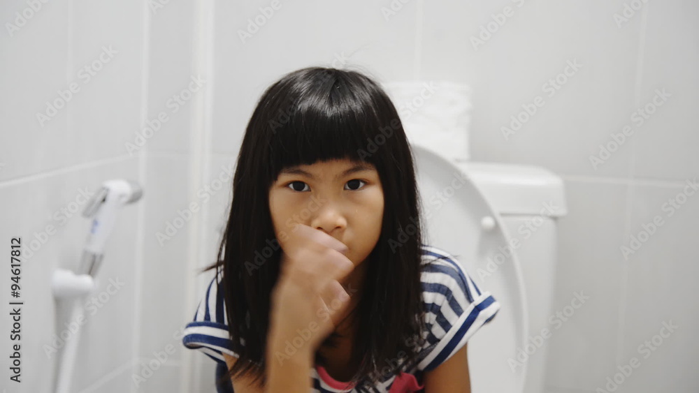 Asian girl using toilet at home. Stock 비디오 | Adobe Stock