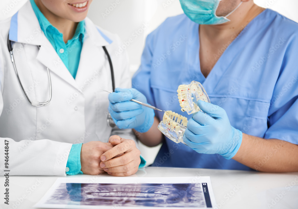 Medical colleagues discussing teeth problems in dental clinic. Young ...