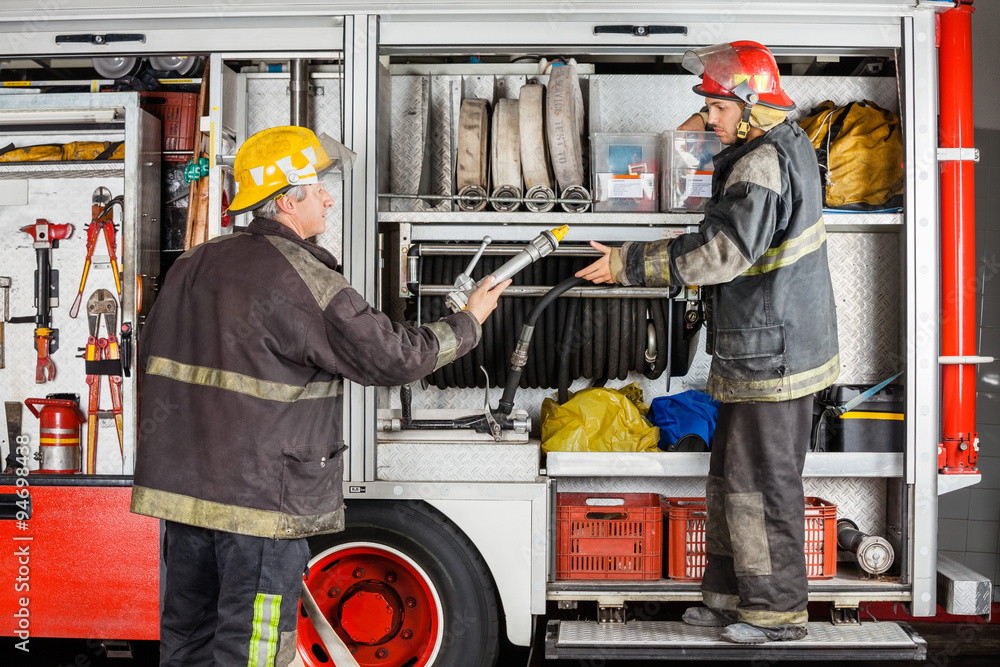 Firefighters Working At Truck In Fire Station Stock Photo | Adobe Stock