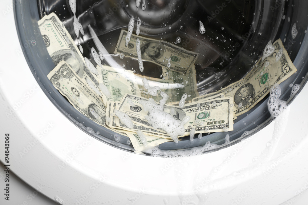 Laundering of dirty money in washing machine, close up Stock Photo ...