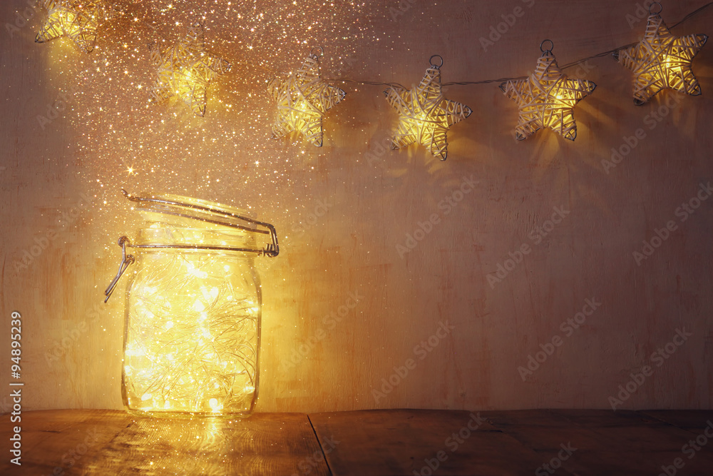 low key and vintage filtered image of fairy lights in mason jar with ...