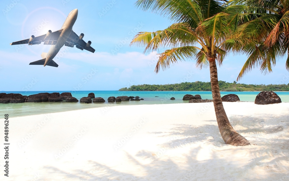 passenger plane flying over beautiful blue ocean and island in purity ...