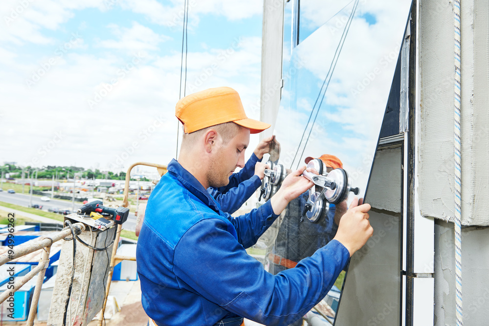 builders worker installing glass windows on facade Stock Photo | Adobe ...