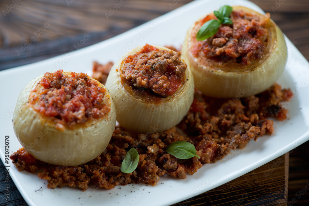 Closeup of onions stuffed with ground beef meat and then baked Stock ...