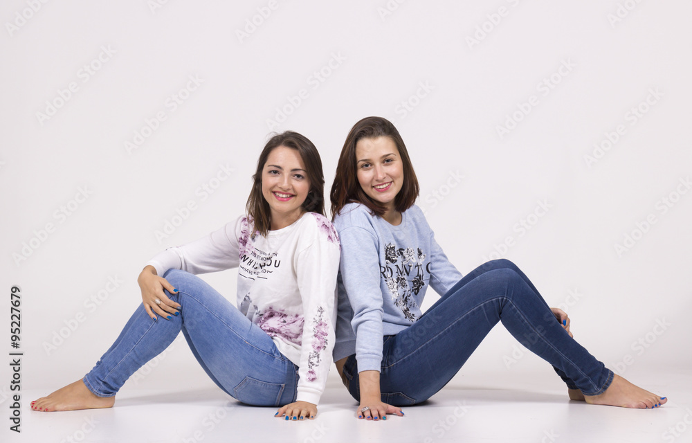 Two lookalike sisters, cute and intimate portrait in studio Stock Photo ...