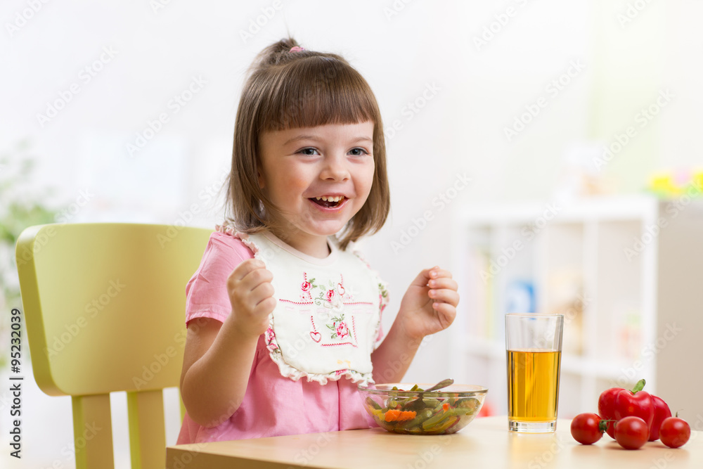 Toddler sitting at table food ready to eat in the nursery. Stock Photo ...