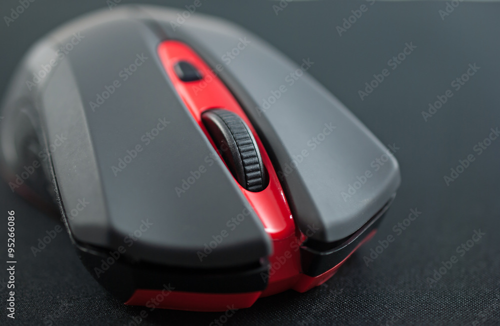 Close up of a scroll wheel of a wireless mouse. Black and red wireless ...