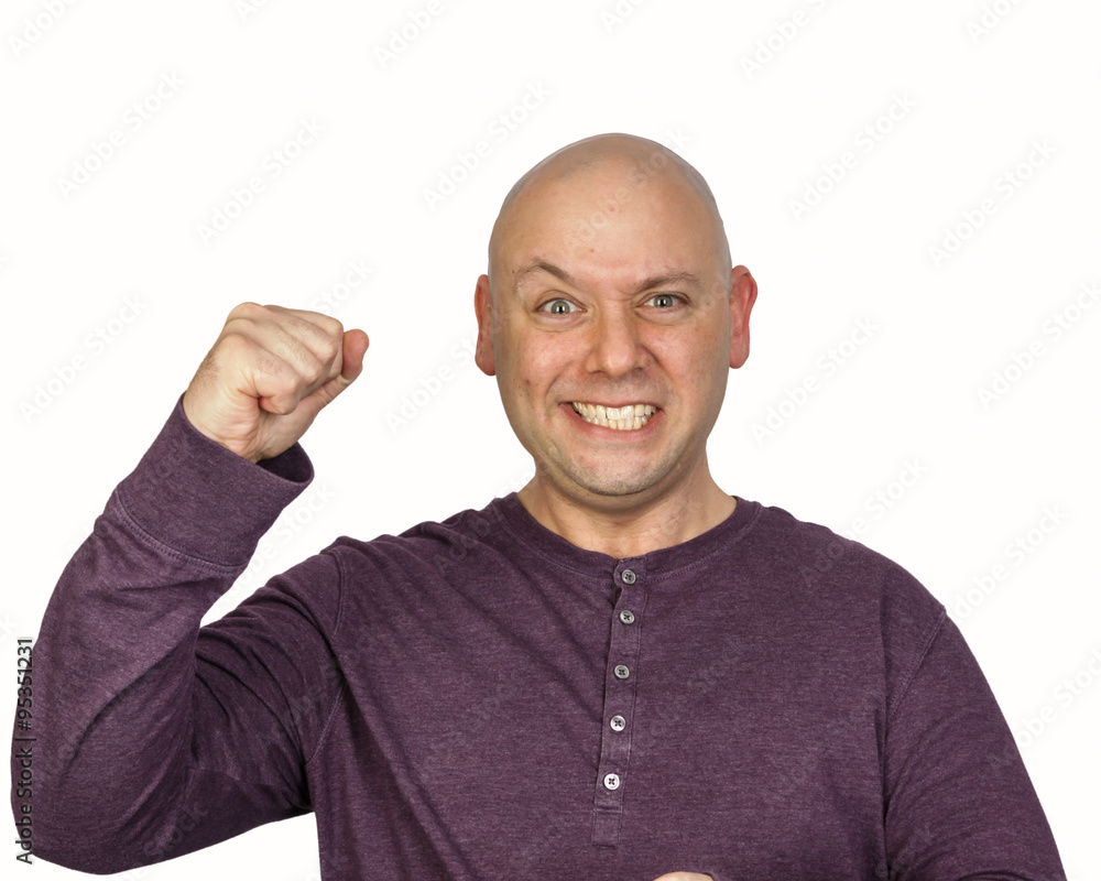 Bald man in studio portrait on white background pumps his fist in the ...