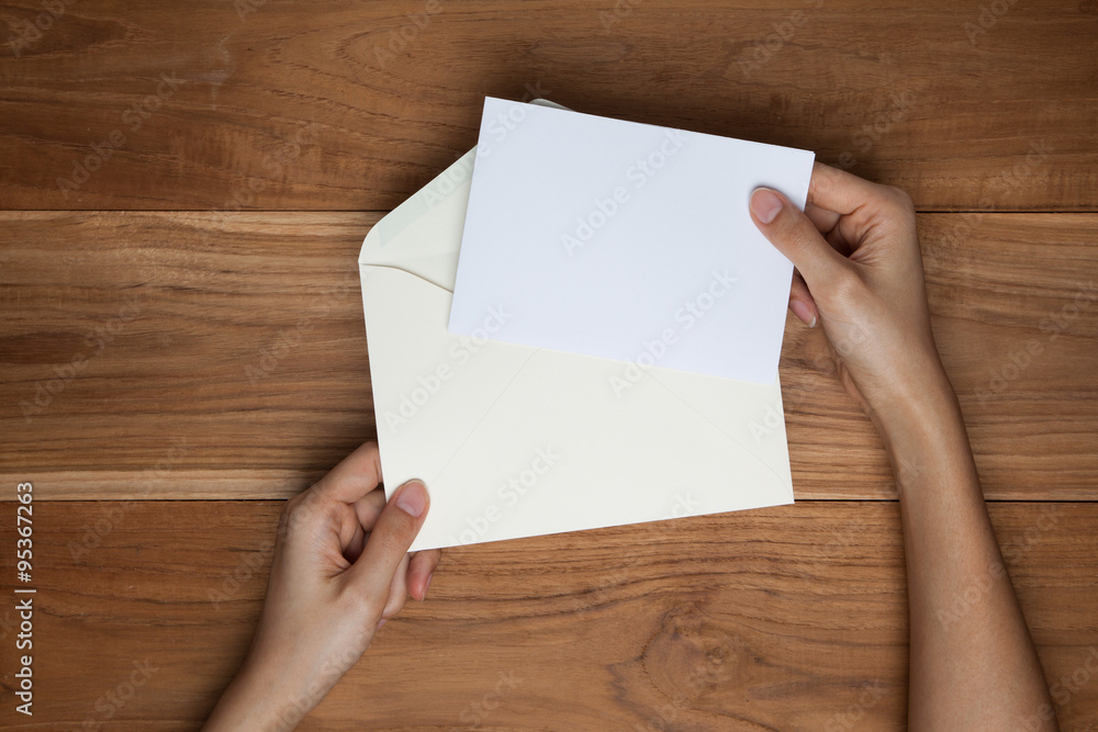 A female(woman) hand hold(open) a envelope and post card on the Stock ...