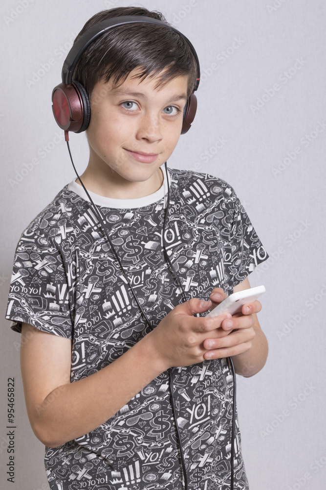 Young Boy Listening To Music With Headphones Stock Photo | Adobe Stock