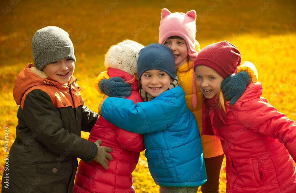 group of happy children hugging in autumn park Stock Photo | Adobe Stock
