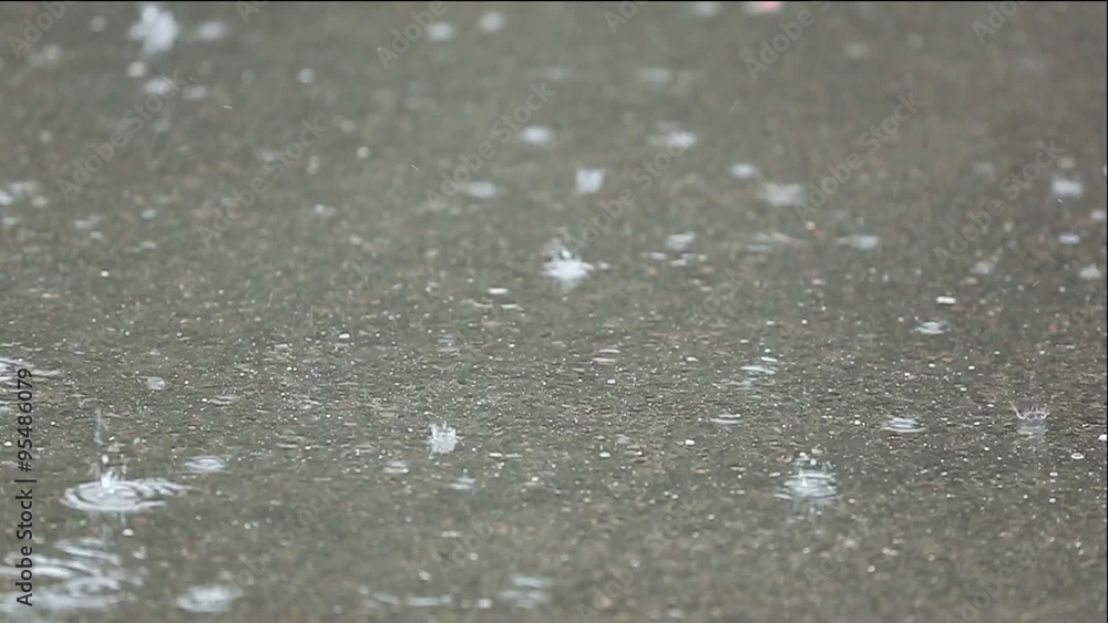 Heavy rainstorm falling onto road slowed down to capture detail Stock ...