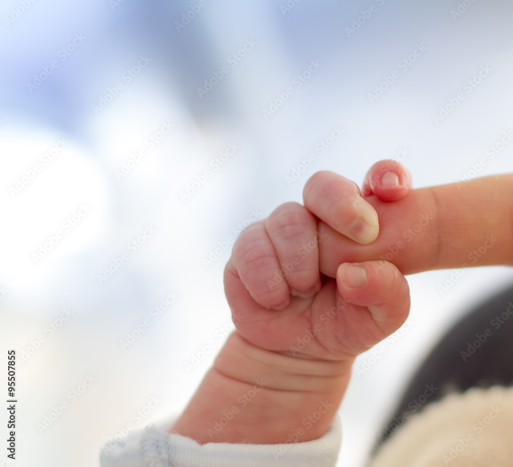Newborn baby touching his mother hand Photos | Adobe Stock