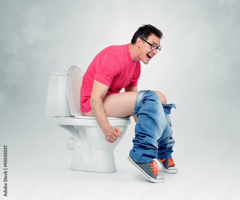 Man with glasses straining on the toilet. The concept of situation ...