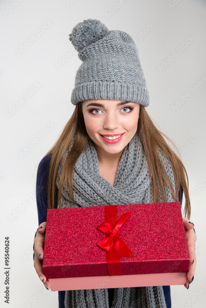 Smiling woman giving gift box at camera Stock-Foto | Adobe Stock