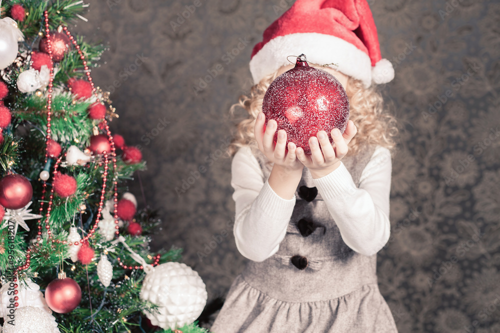 Funny girl decorating a christmas tree Stock Photo | Adobe Stock