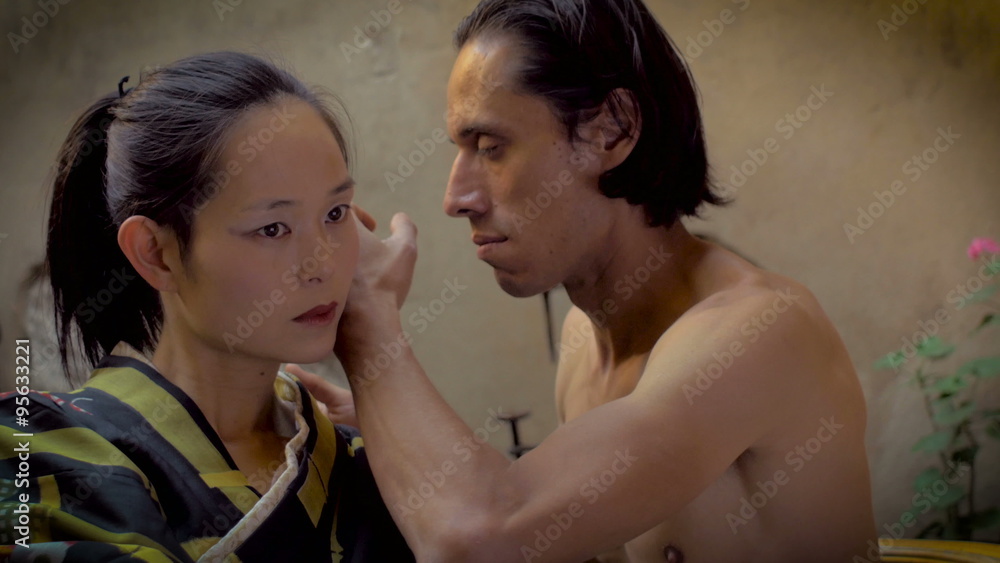 A Japanese woman in a traditional geisha outfit and a shirtless Mexican ...