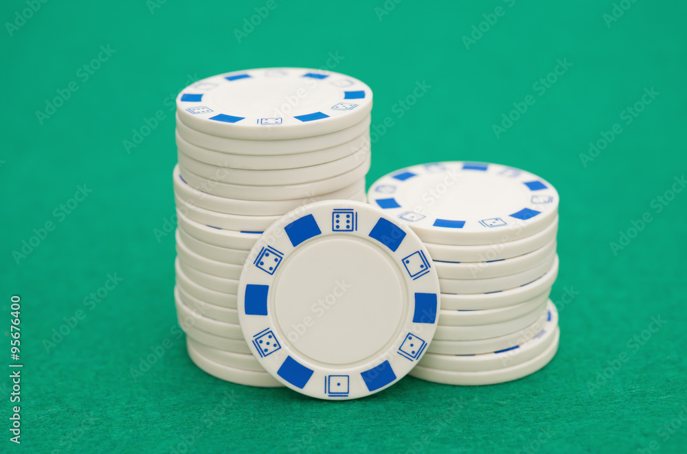 lots of white poker chips on green casino table Stock Photo | Adobe Stock