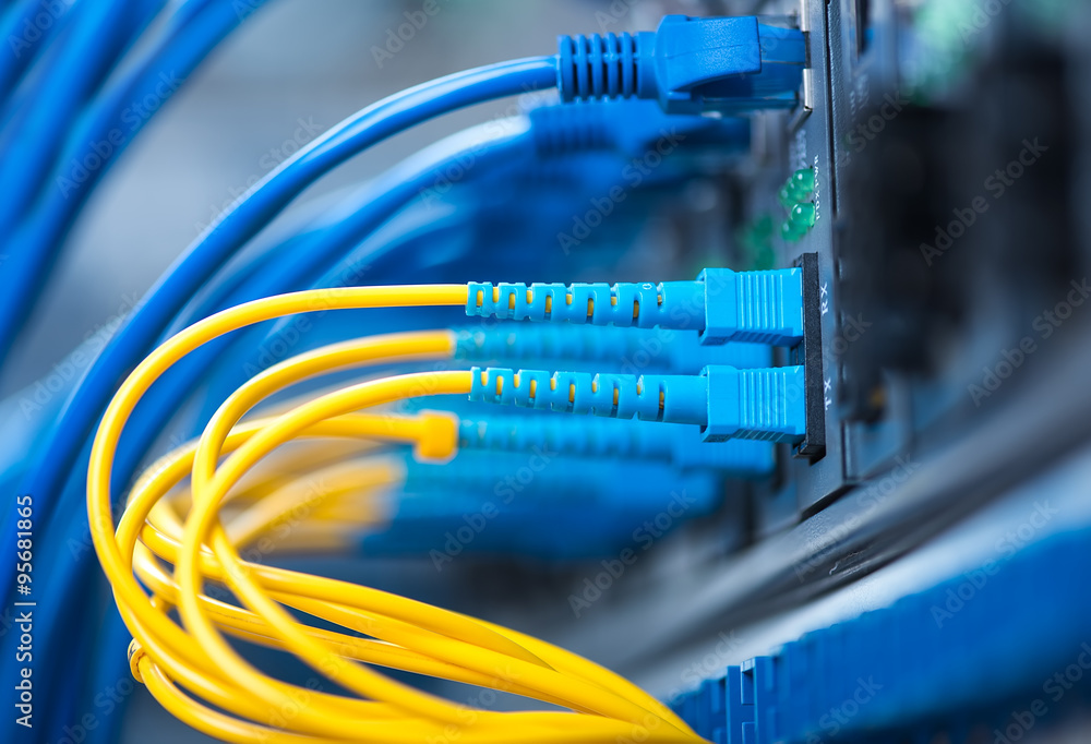 Fiber Optic cables connected to an optic ports and Network cable Stock ...