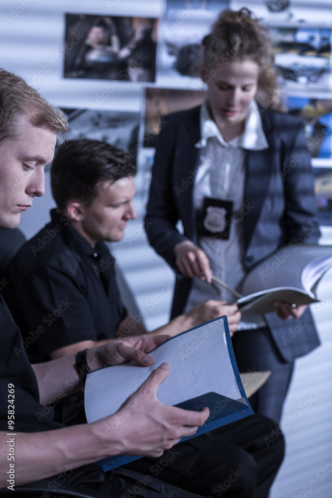 Police officer reading files Stock Photo | Adobe Stock