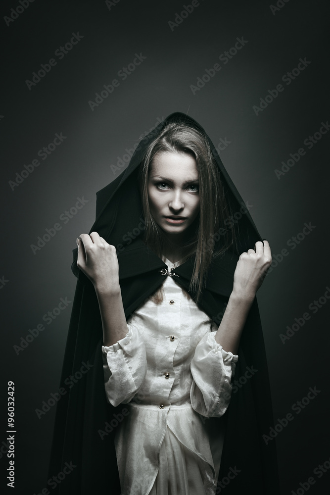 Beautiful vampire with black hood Stock Photo | Adobe Stock