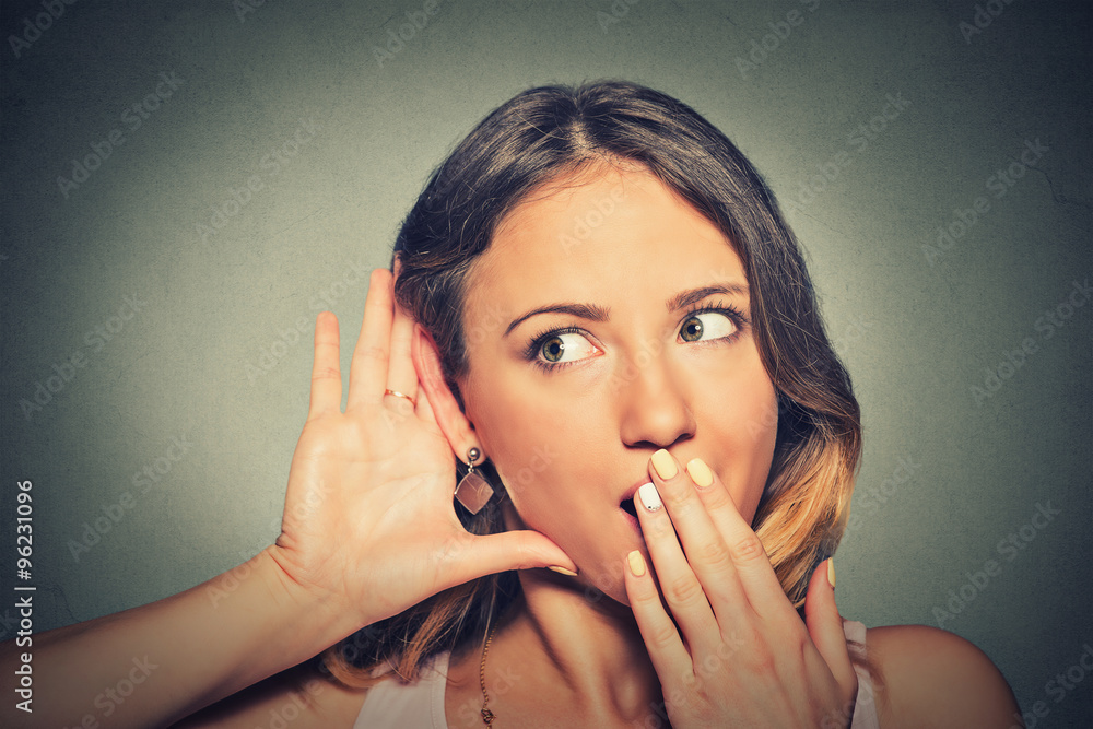 surprised young nosy woman hand to ear gesture carefully secretly ...