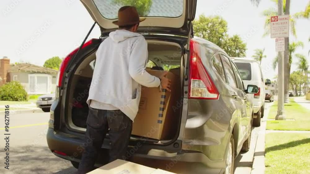 Mexcian man loading boxes into car Stock Video | Adobe Stock