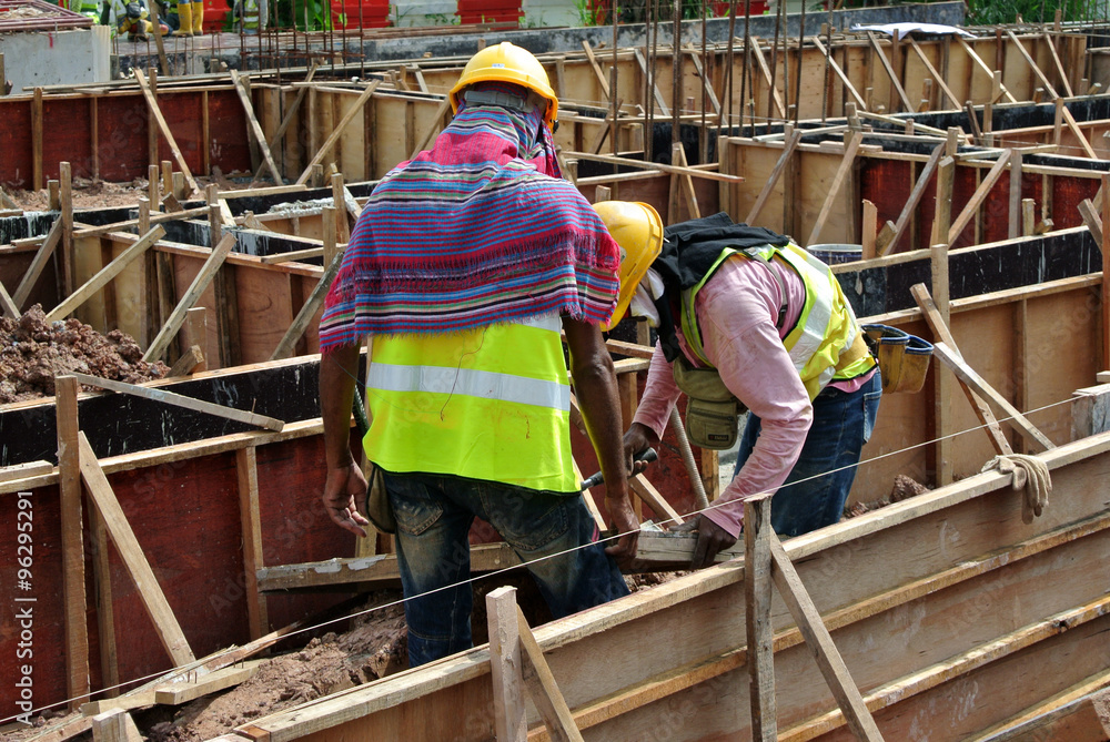 Construction workers fabricating ground beam formwork Stock Photo ...