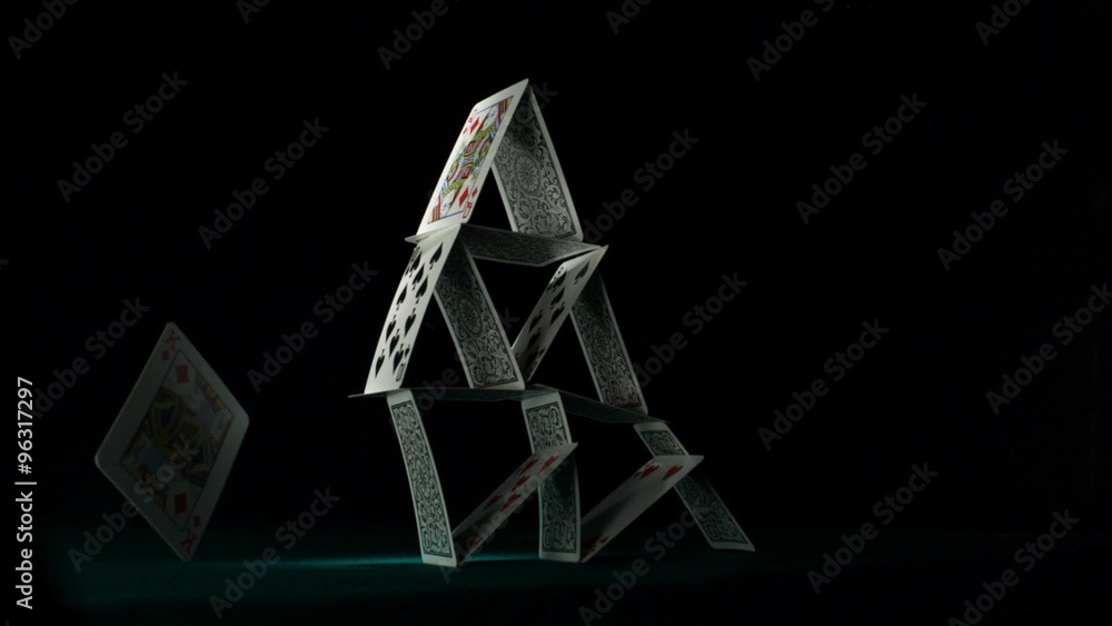 Pyramid house of playing cards falling down shooting with high speed ...