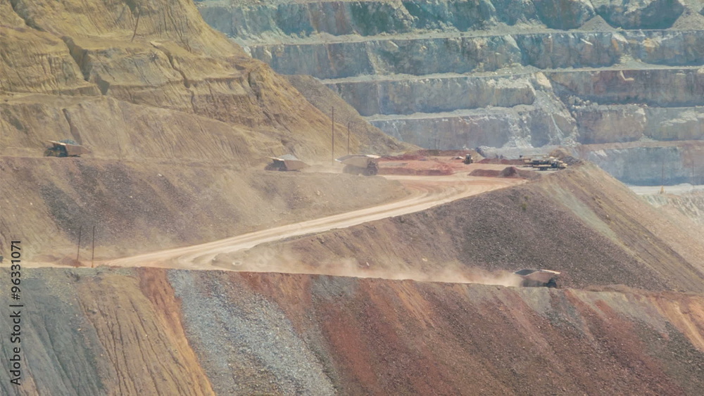 Telephoto shot of tipper trucks in giant open air copper mine. Live ...