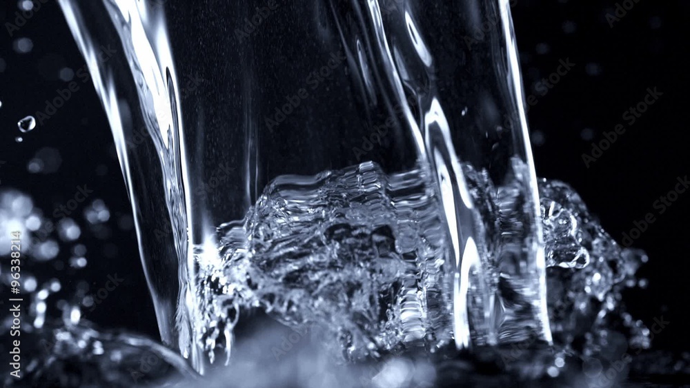 Pouring water on black background shooting with high speed camera ...