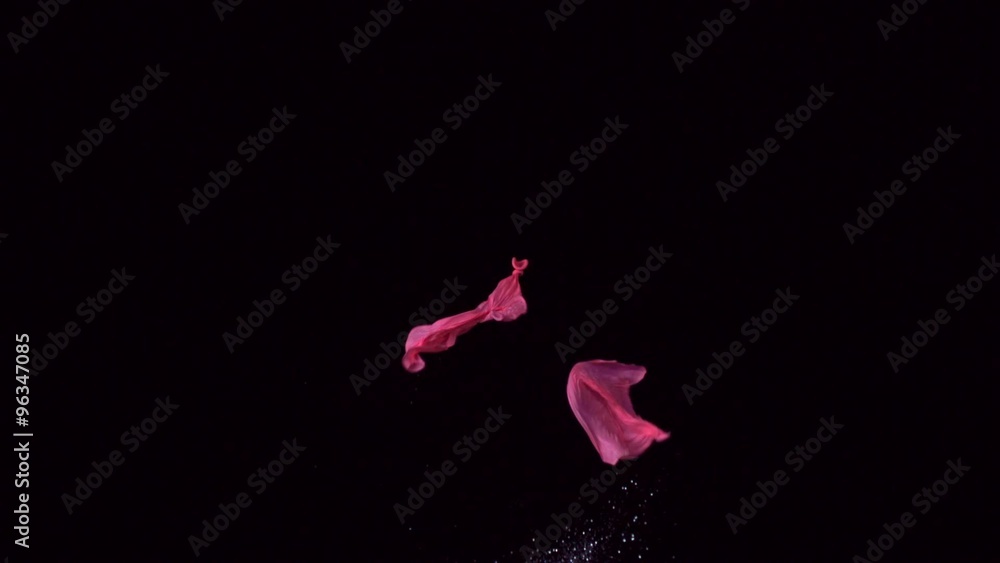 Popping balloon and gliter coming out shooting with high speed camera ...