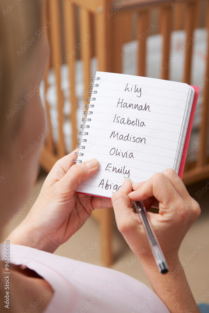 Woman Writing Possible Names For Baby Girl In Nursery Stock Photo ...