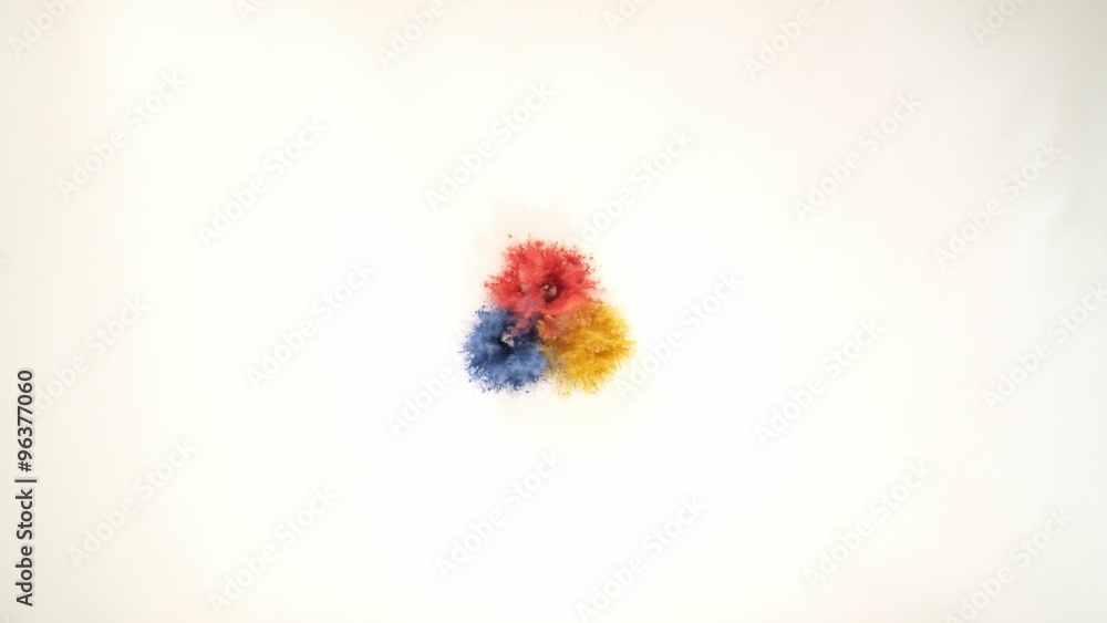 Colorful powder/particles fly after being exploded against white ...