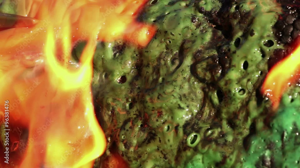 Green plastic burning, melting and dissolving in flame at high ...