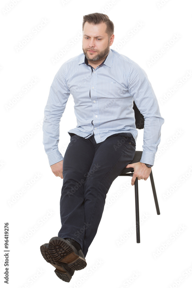man sitting on chair. Isolated white background. legs crossed, holding ...