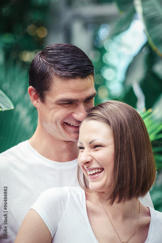 Portrait of two people, man woman girl together, standing among green ...