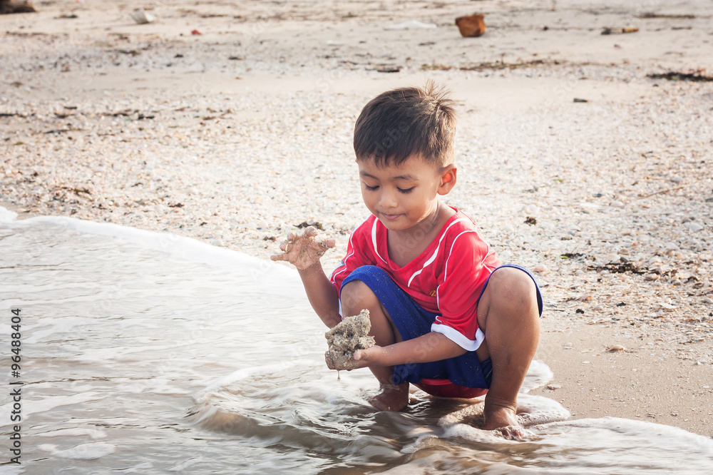 little boy play at the beach Stock Photo | Adobe Stock